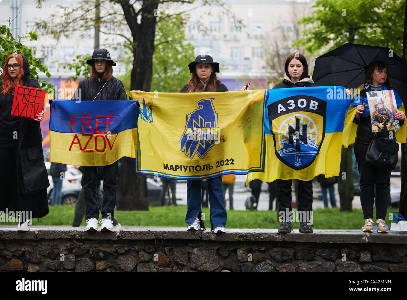 Young Ukrainian girls posing with national flags and symbol o Azov ...