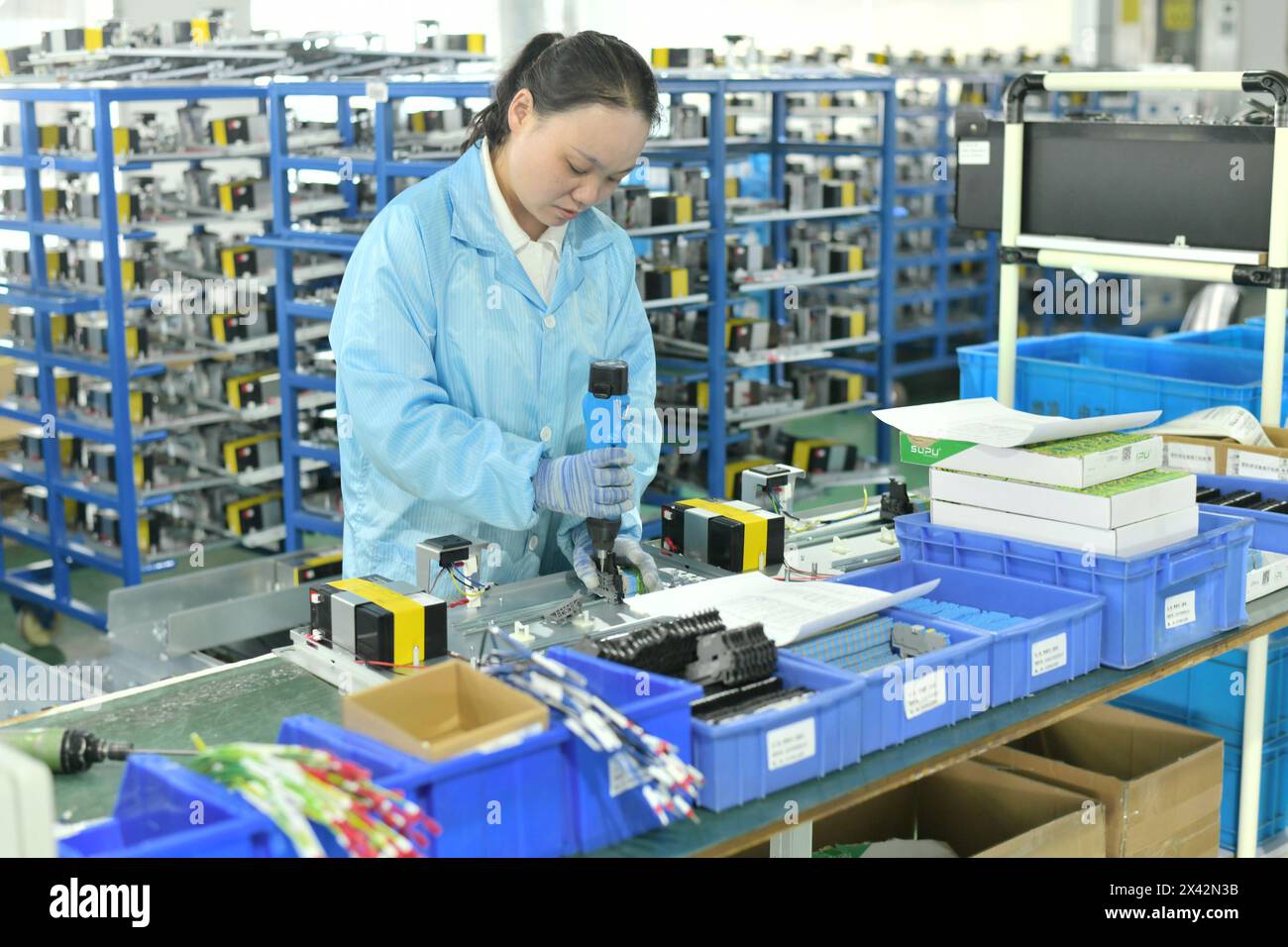 HAIAN, CHINA - APRIL 29, 2024 - A worker is producing a terminal box ...