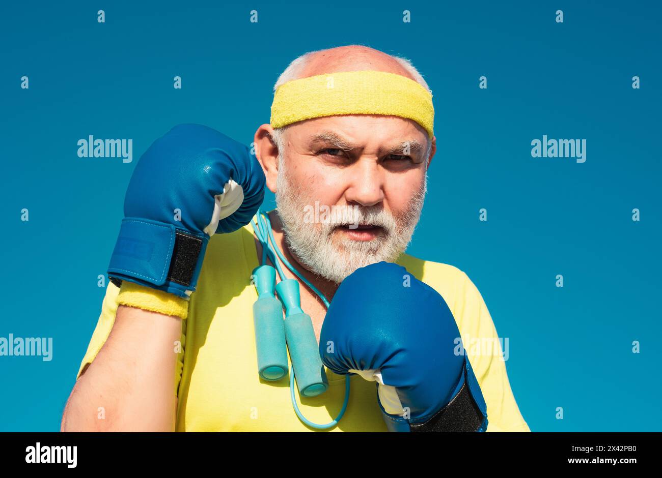 Older man boxing - close up portrait. Handsome elderly man practicing ...