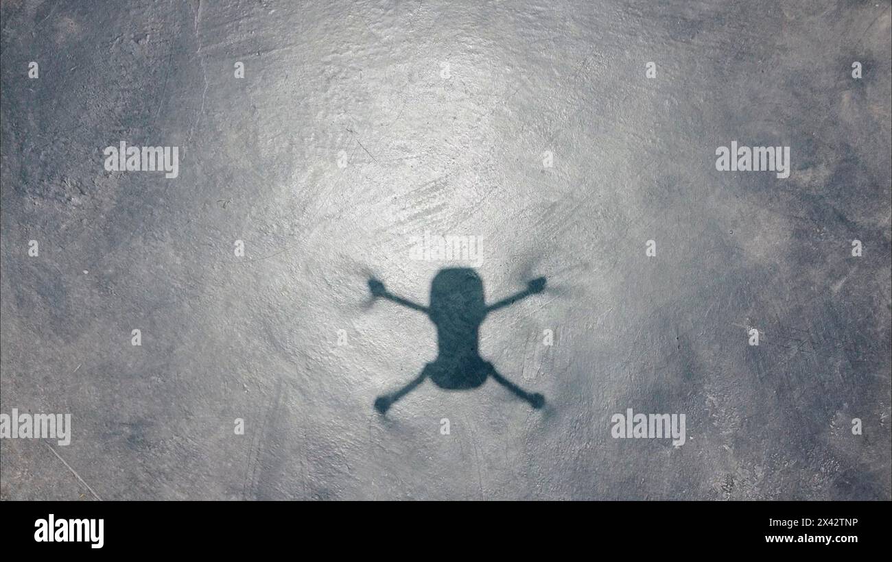 Shadow of a small drone on the pavement Stock Photo - Alamy