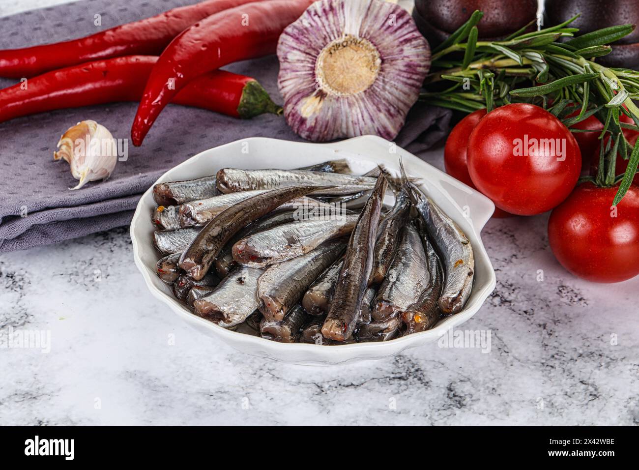 Pickled anchovy fish in the plate Stock Photo - Alamy