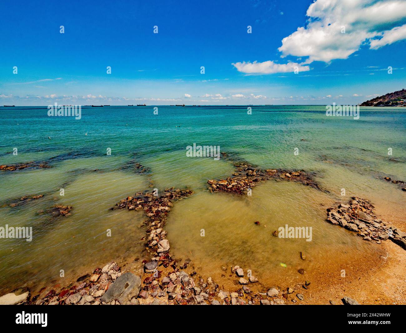 shallow beach pebbles brown green blue water Vung Tau Vietnam Stock ...