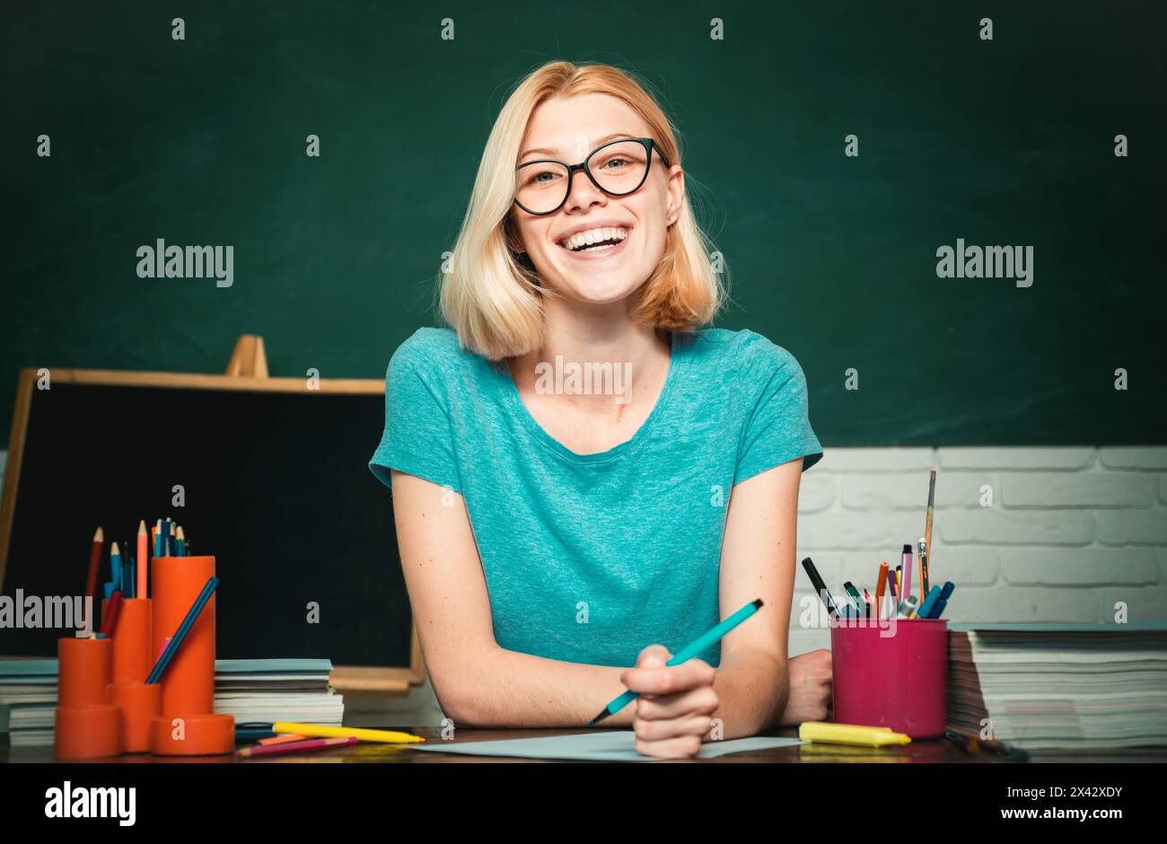 Female student taking notes from a book in college. Student. Portrait ...