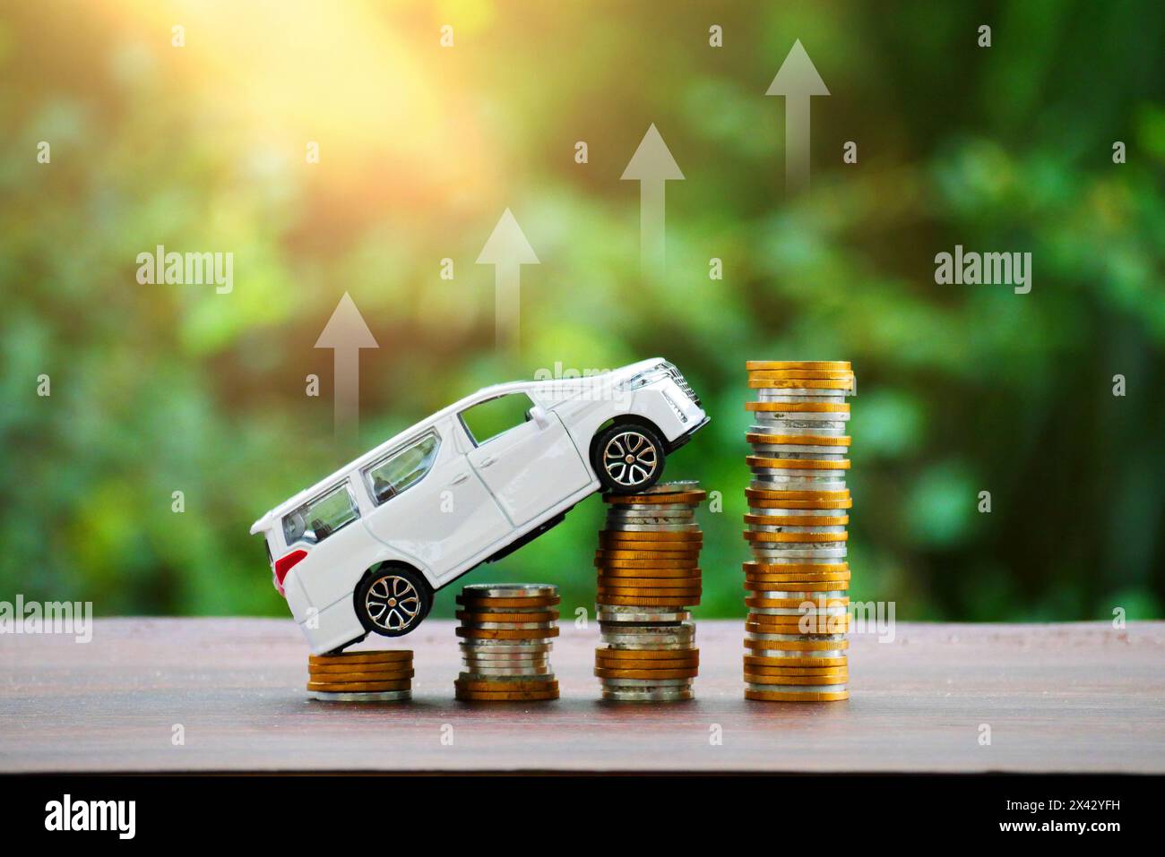 Pile of coins, toy cars on table. Concept of saving and managing money ...