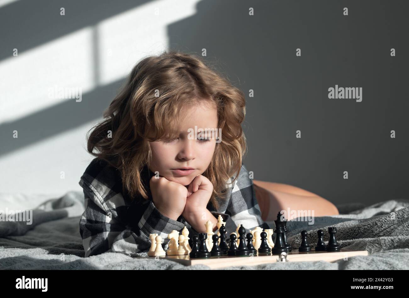 Chess game with kids at home. Kid playing chess. Child thinking near ...