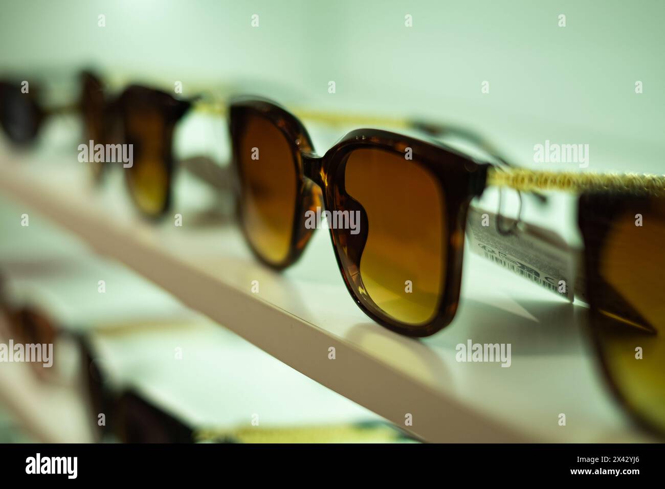 Storefront shelves of various modern sunglasses in retail store ...