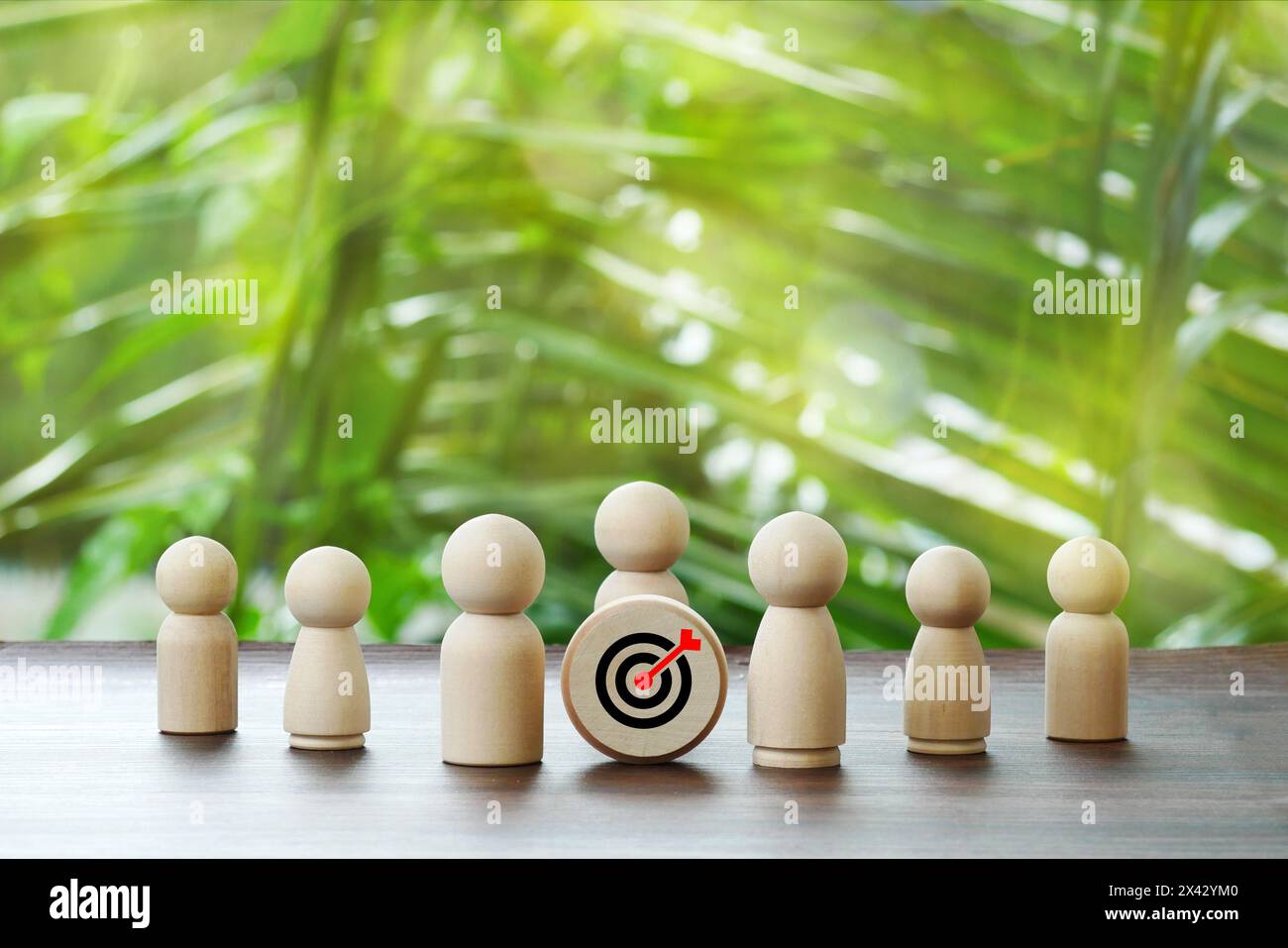 Target dart board with rows of wooden dolls. Concept of business ...