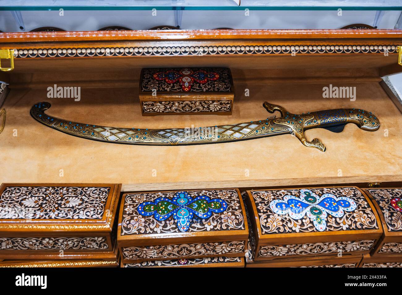 traditional Arabic Uzbek saber and wooden carved caskets in a souvenir ...