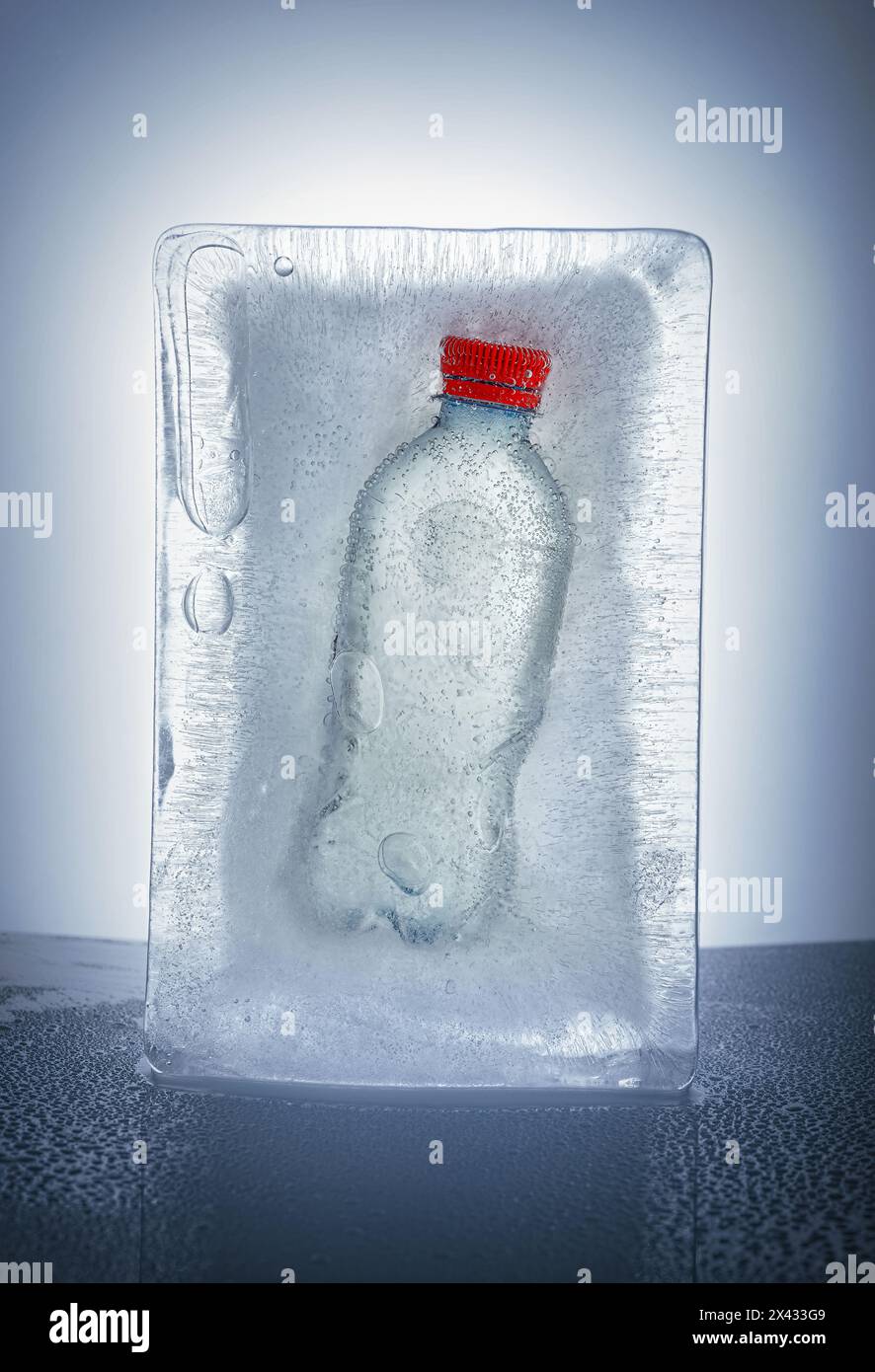 Bottle frozen in a piece of ice. Bubbles and cracks in the ice ...