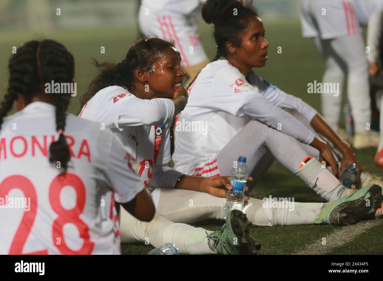 Dhaka Rangers FC players sip water during a cooling break to avoid overheating during the UCB ...