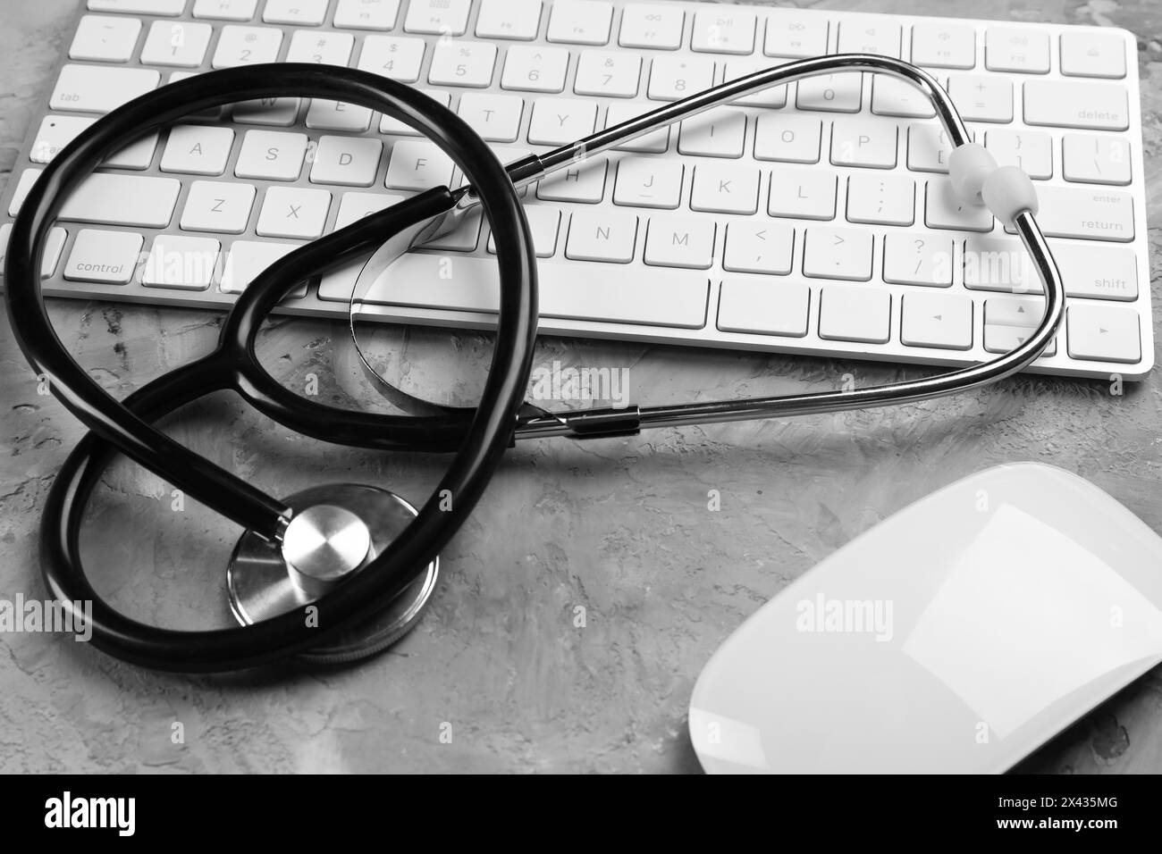 Medical stethoscope, keyboard and mouse on grey textured table Stock ...