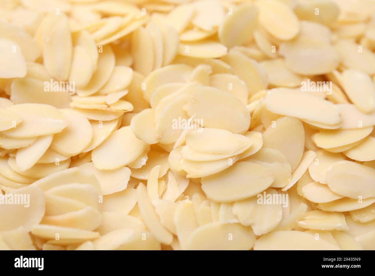 Fresh almond flakes as background, above view Stock Photo - Alamy