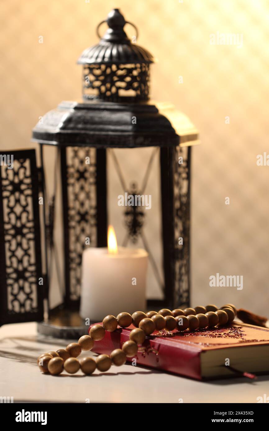 Arabic lantern, Quran and misbaha on white table Stock Photo - Alamy