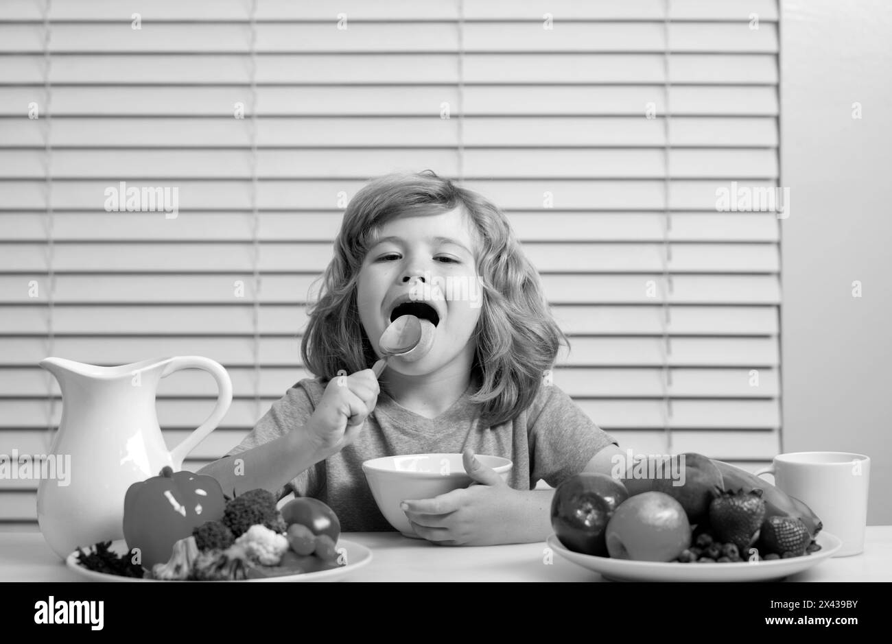 Hunger, appetite concept. Little child boy lick spoon having healthy ...