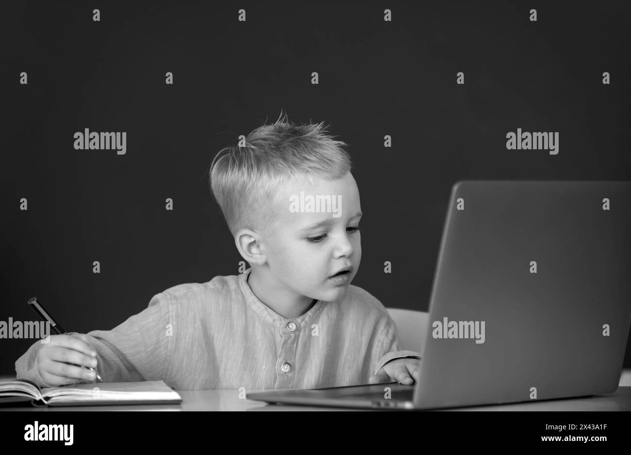 Cute little child using laptop computer, kid boy studying through ...