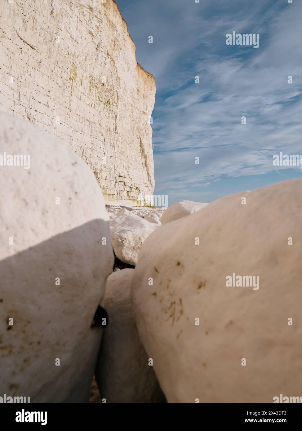 Low angle view of the white chalk cliffs and rocks at Birling Gap chalk ...