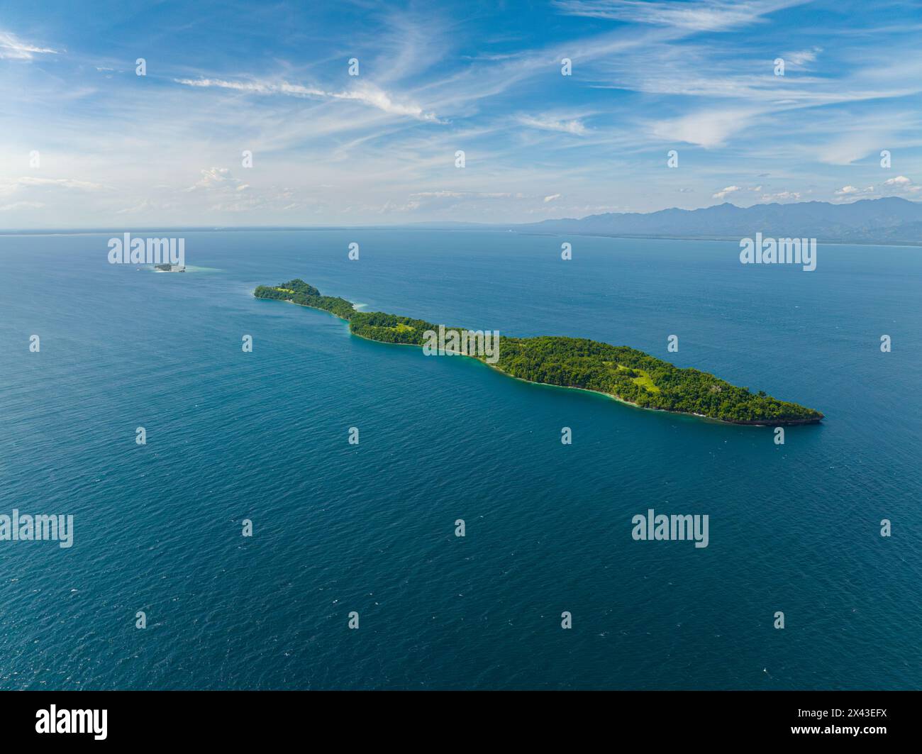 Tropical island with deep blue sea. Blue sky and clouds. Ligid Island ...