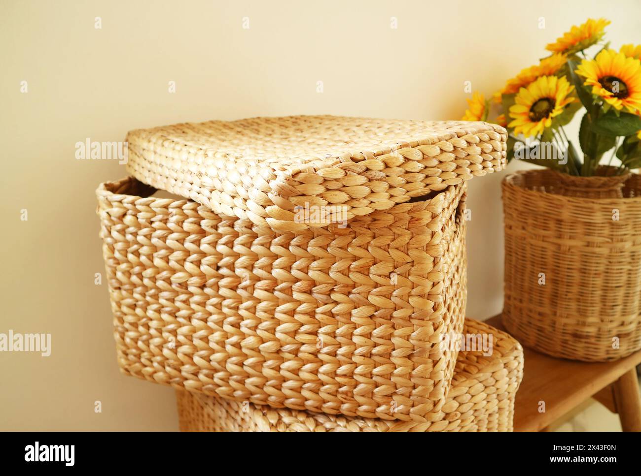 Summer home decor with stack of wicker boxes with bunch of sunflowers ...
