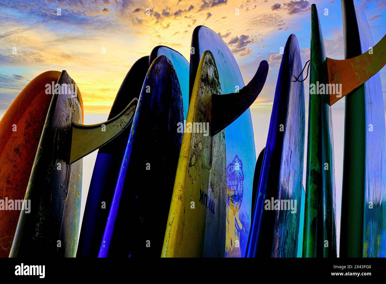 Stacked surf boards at sunset after a day of surf school in Canggu ...