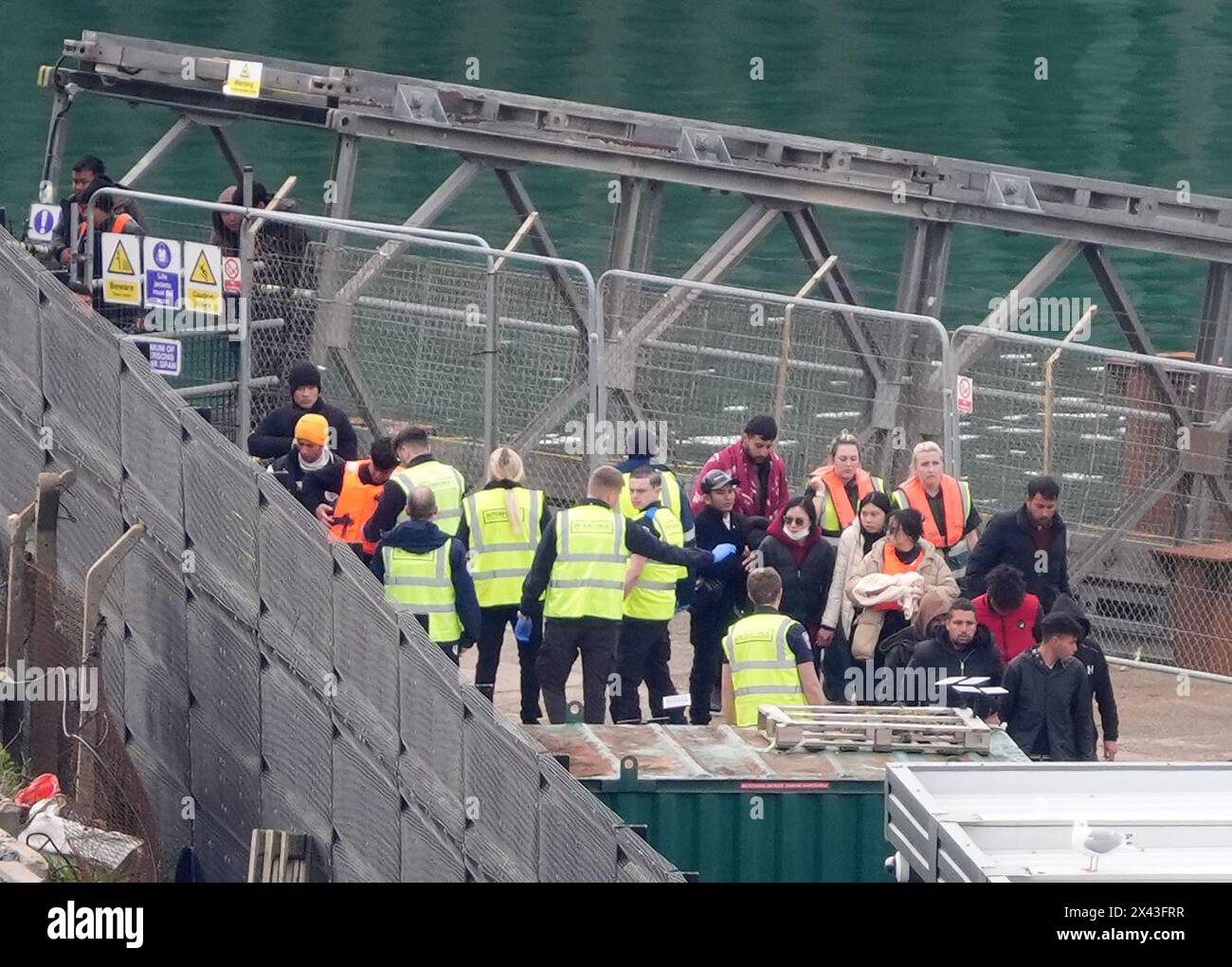 A group of people thought to be migrants are brought in to Dover, Kent ...