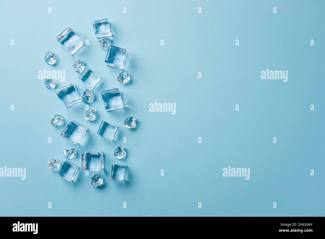 top view of ice cubes of different sizes on blue background Stock Photo ...