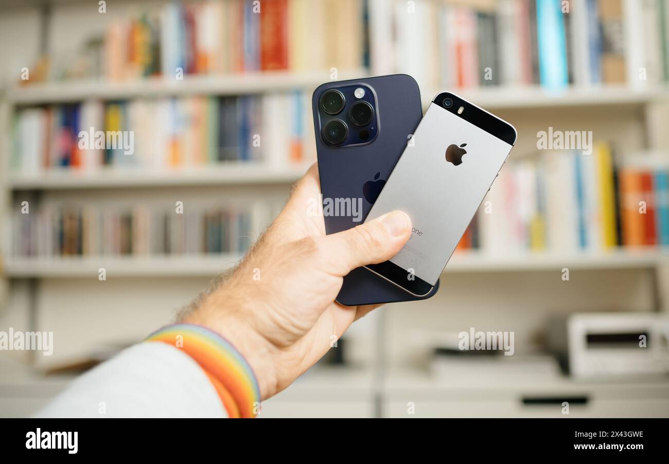 Paris, France- Sep 29, 2022: Hand holding iPhone 14 Pro over an iPhone ...