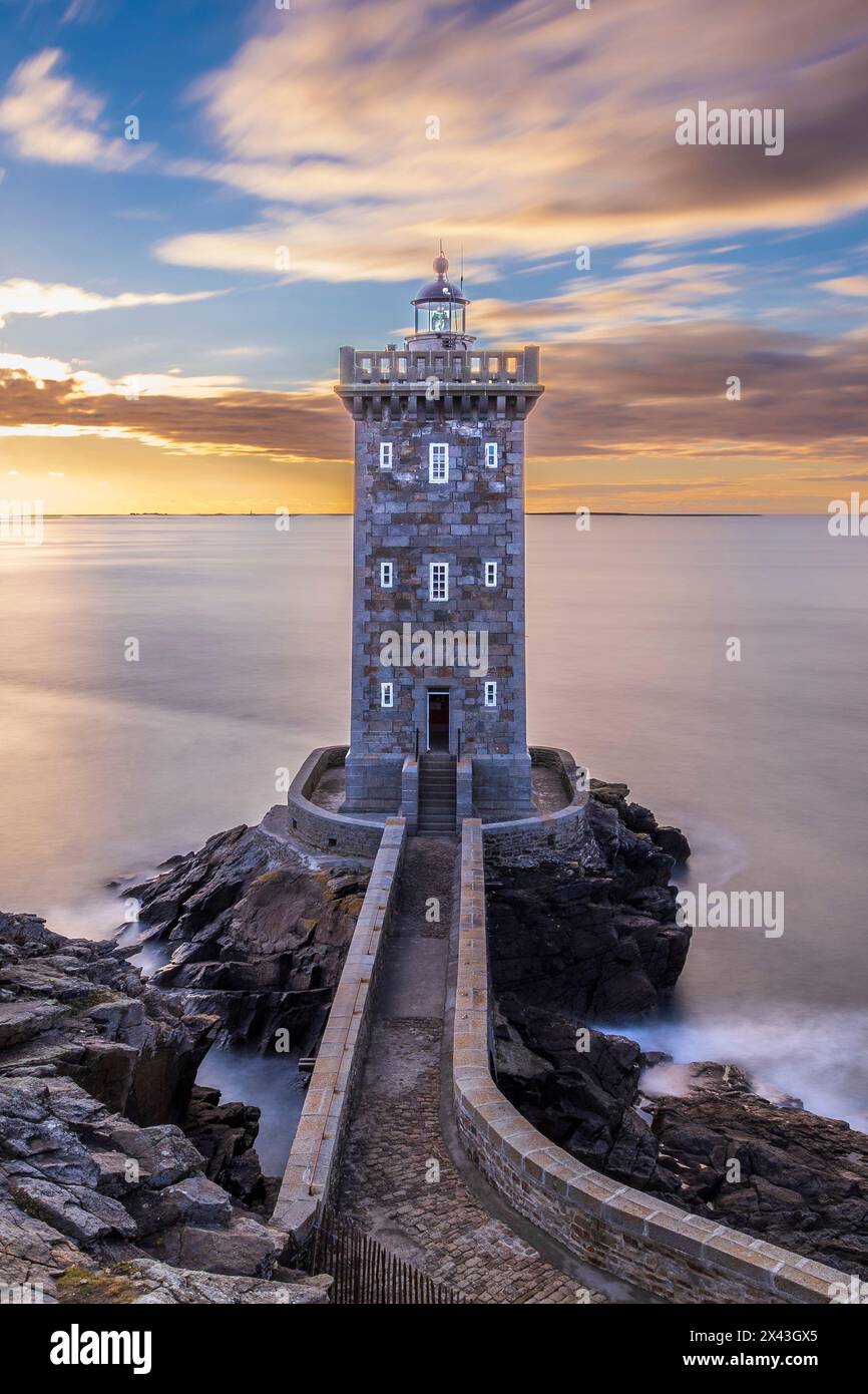 France, Brittany, Le Conquet. Sun setting at the Kermorvan Lighthouse ...