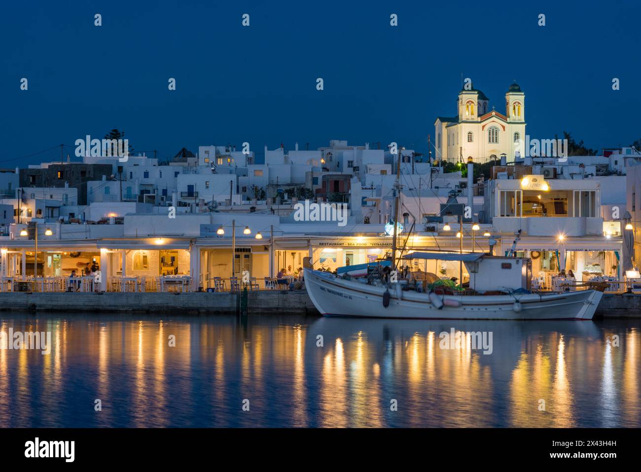 A view of the village of Naousa and dock at night. Naousa, Paros Island ...