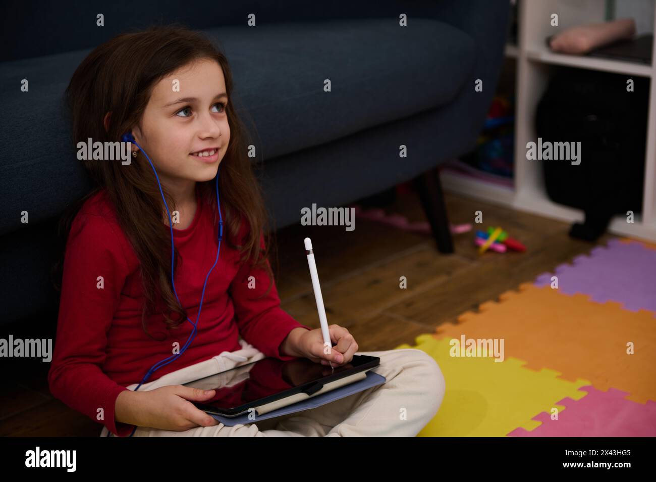 Adorable smart little child girl holding digital tablet and white ...