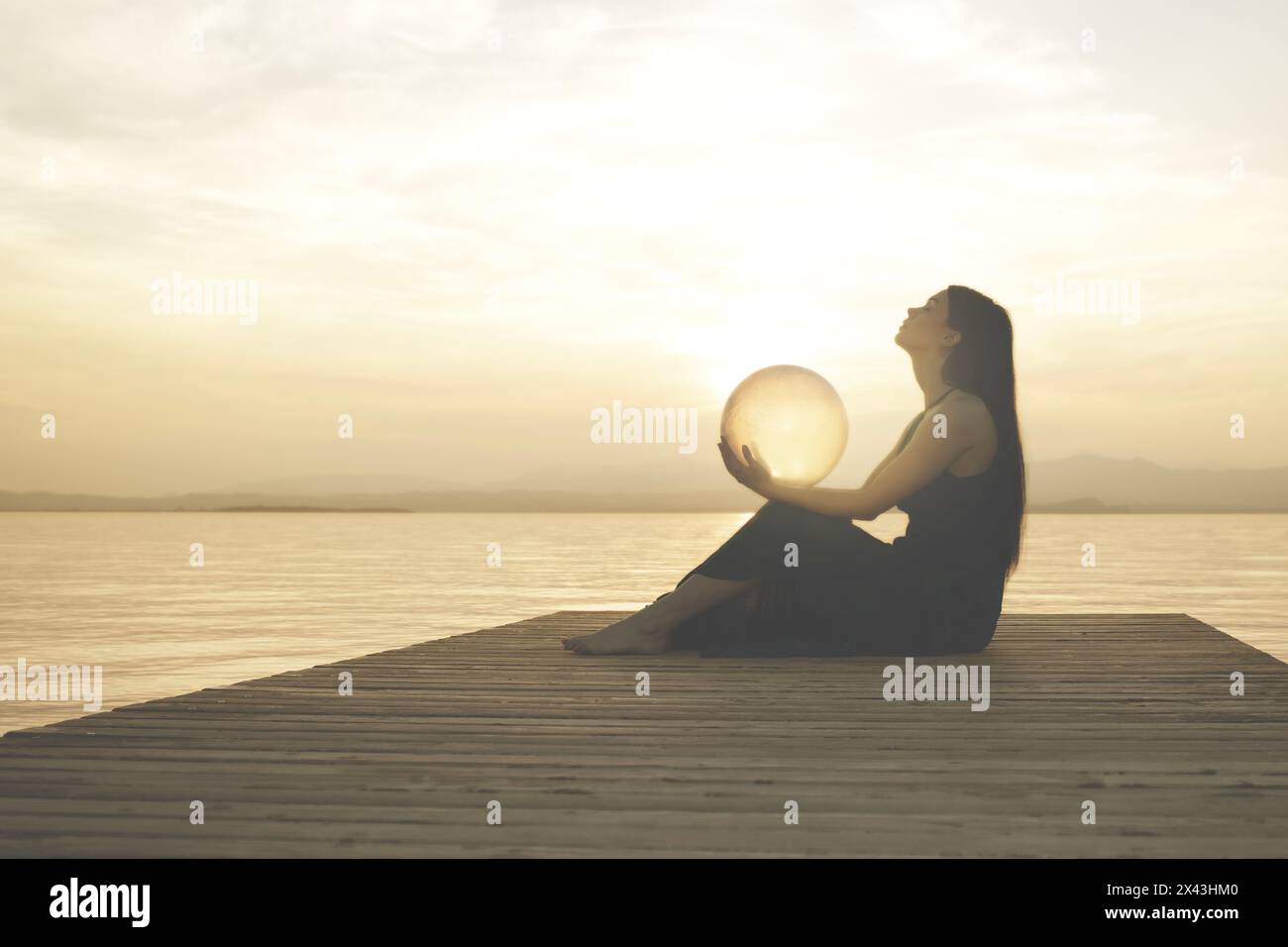woman protecting a magical sphere illuminated by the sun that releases ...