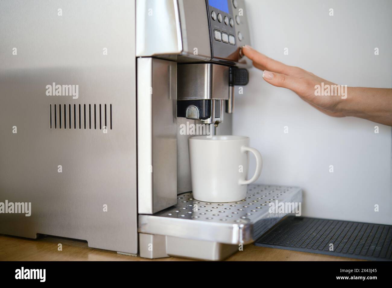 Female hand presses coffee button in coffee machine Stock Photo - Alamy