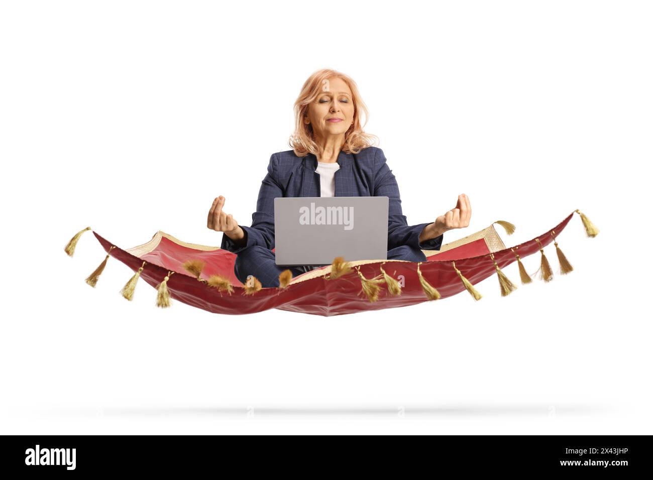 Businesswoman with a laptop computer sitting in a meditation pose on a ...
