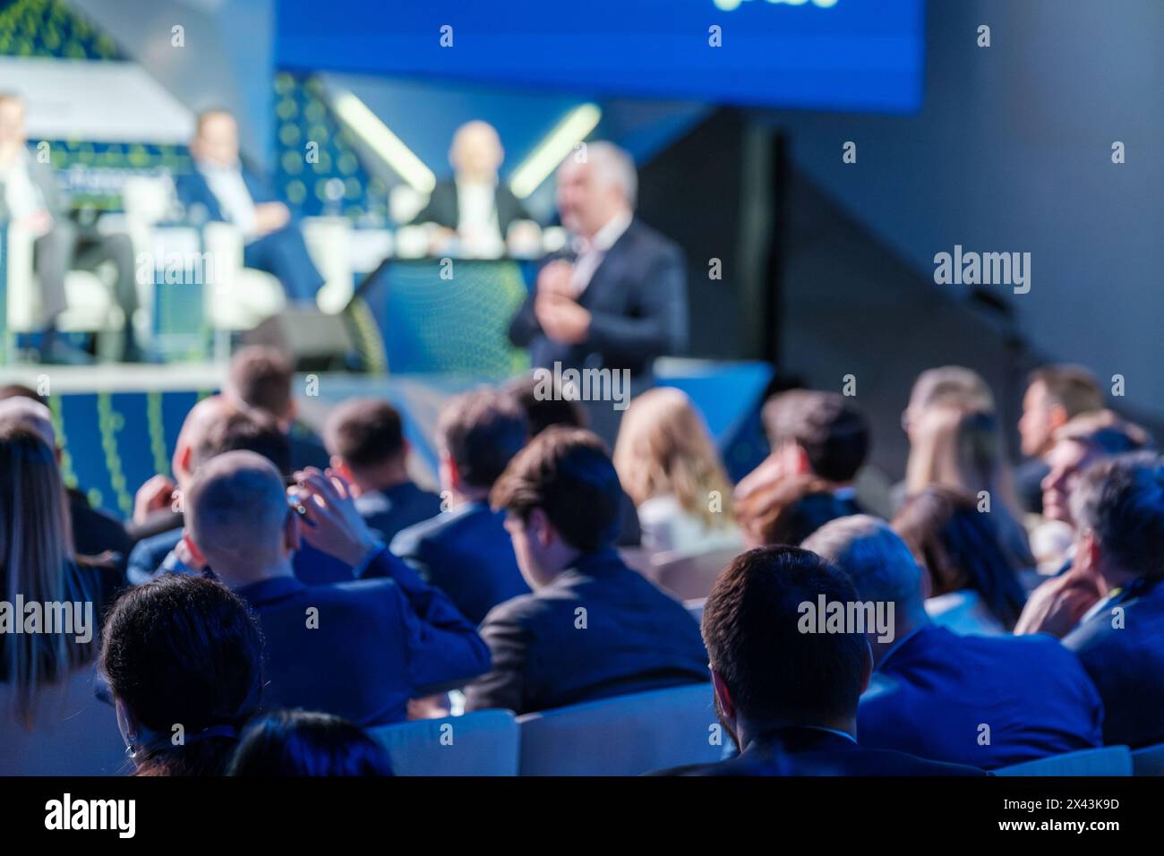 Focused view of a professional speaker engaging with a well-dressed ...