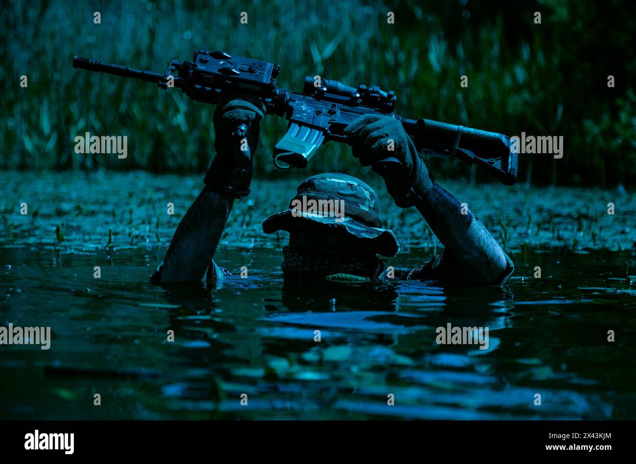 A soldier moves in the heart of a marsh, submerged in swampy waters ...