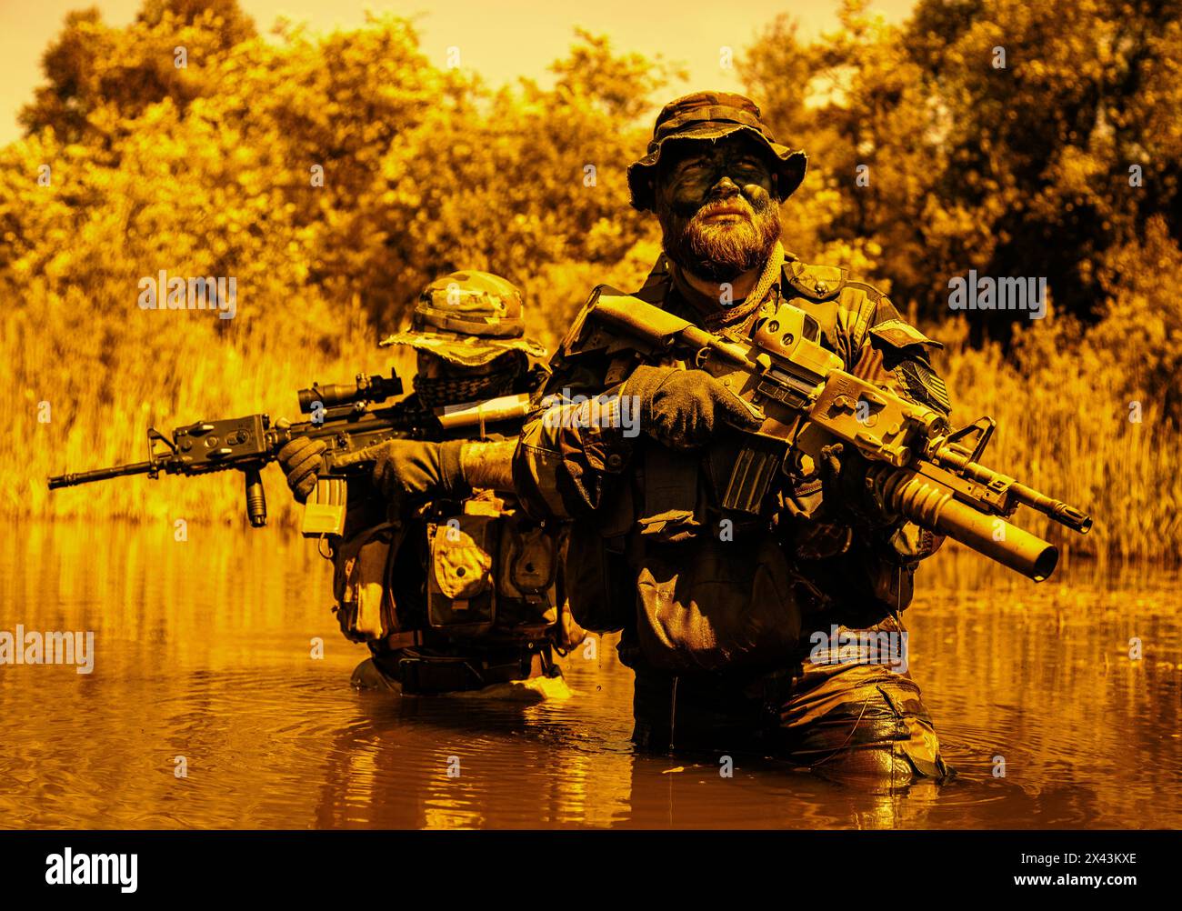 Soldiers move in the heart of a marsh, crossing swampy waters, tropical ...
