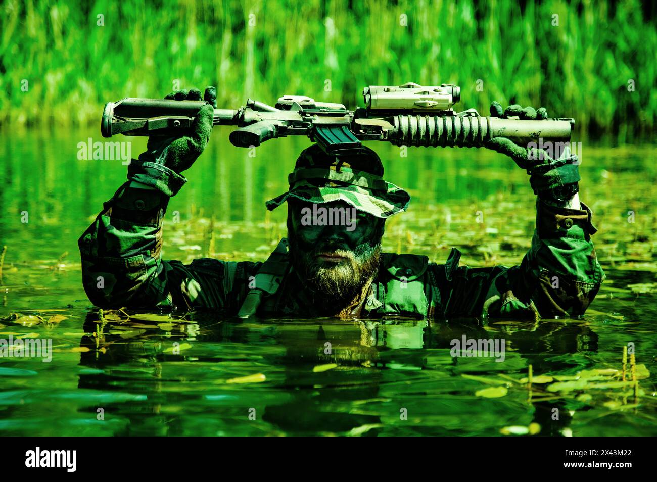 A soldier moves in the heart of a marsh, submerged in swampy waters ...