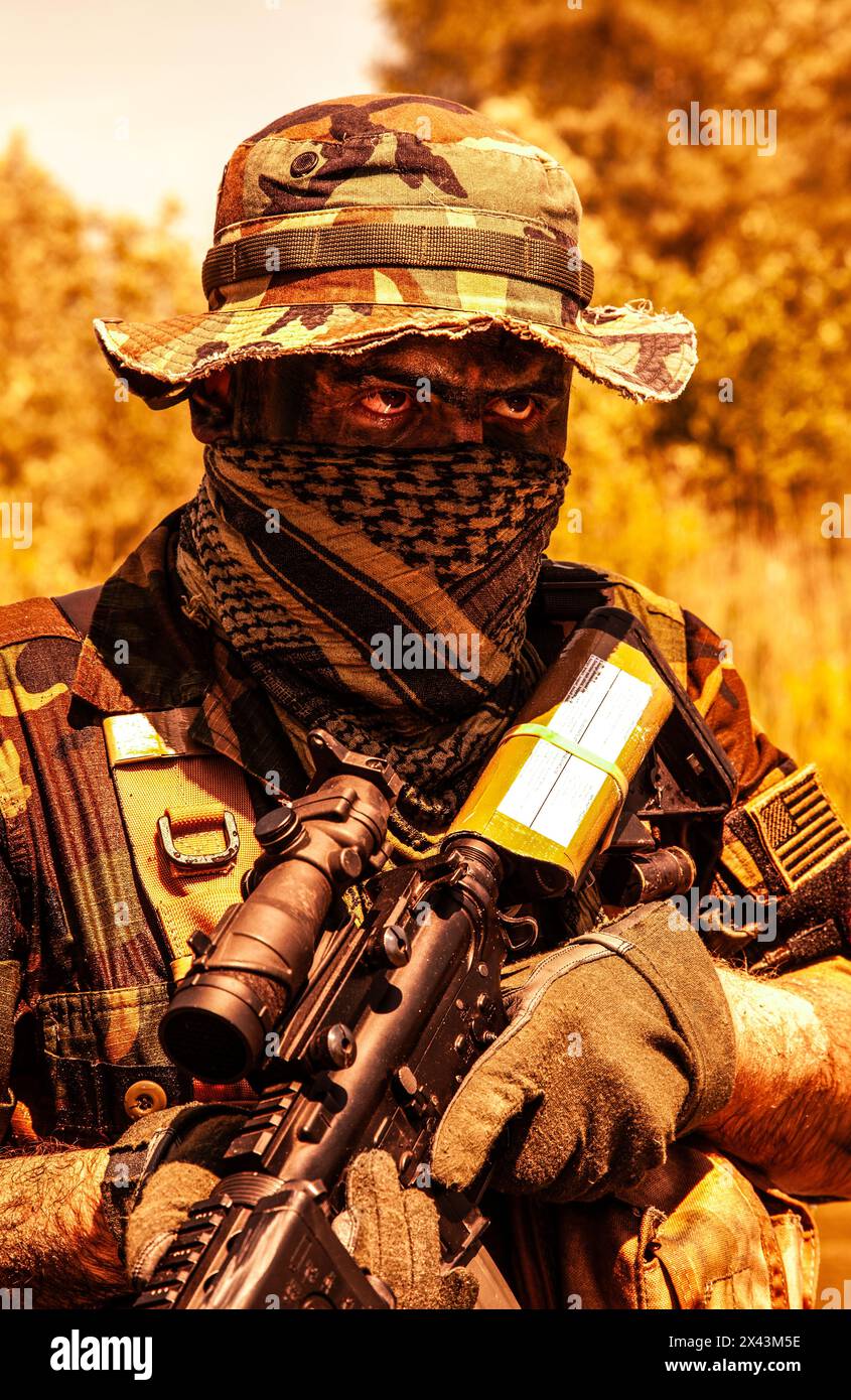 Camouflaged in the foliage, a soldier with piercing eyes holds his rifle, sentinel, harsh ...
