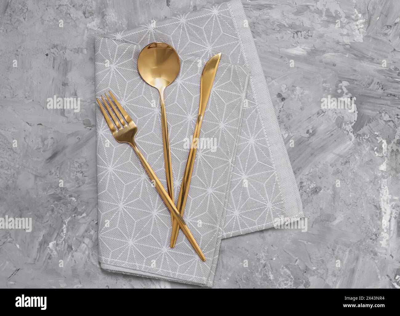 Beautiful cutlery set and kitchen towel on grey table, top view Stock ...