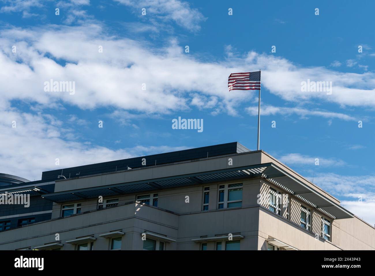Waving American flag against a blue sky. American flag on the roof of ...