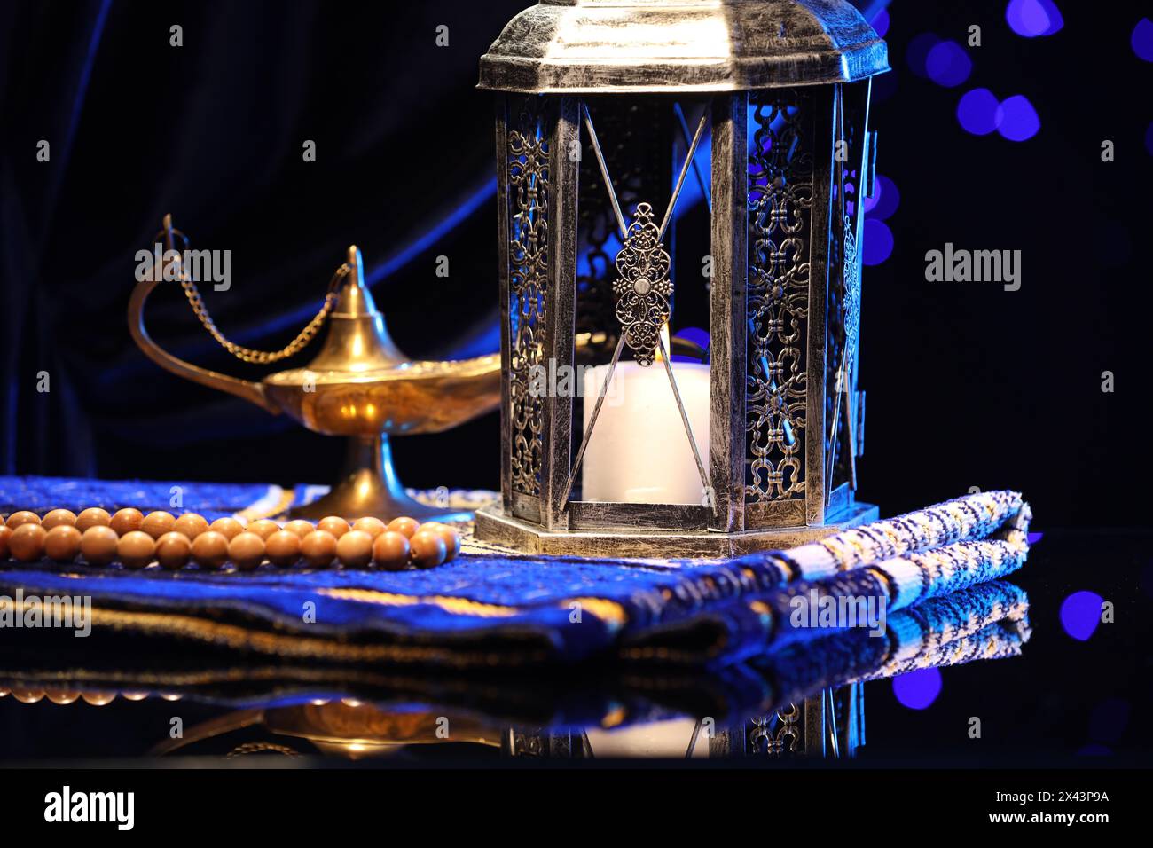 Arabic lantern, misbaha, Aladdin magic lamp and folded prayer mat on ...