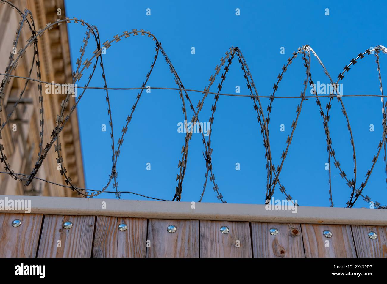Barbed wire on top of a fence against a blue sky. Freedom concept Stock ...