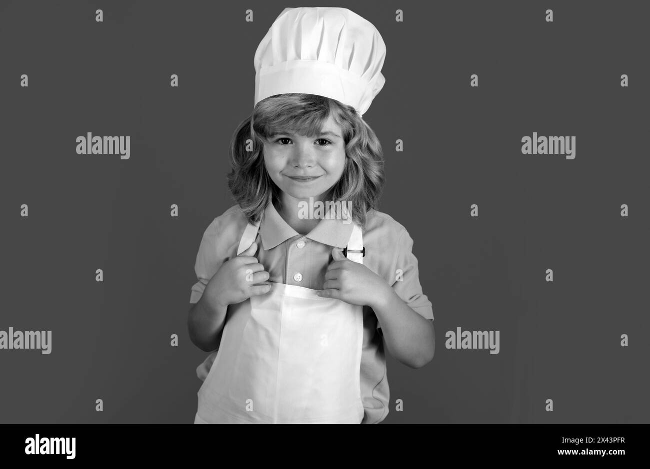 Chef funny face. Child wearing cooker uniform and chef hat Stock Photo ...