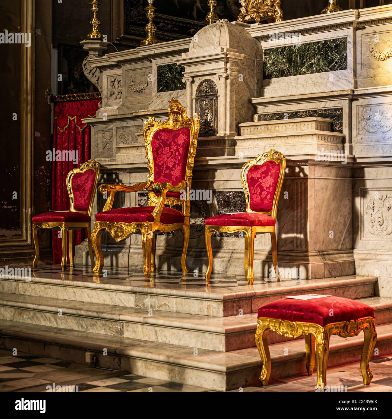 Altar and red velvet chairs in a baroque church in the town of Galatina ...