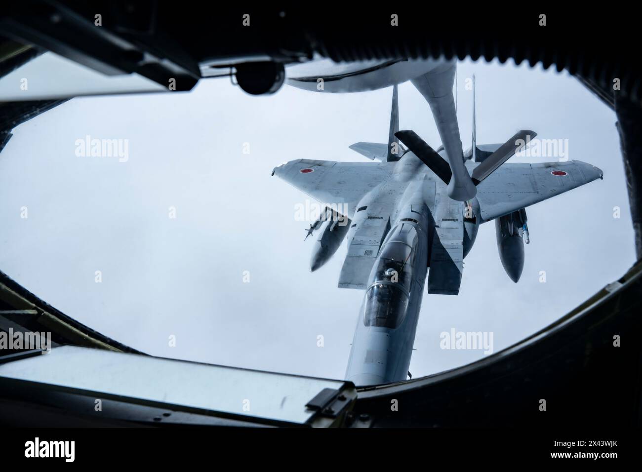 A Japanese Air Self-Defense Force F-15J Eagle refuels from a KC-135 ...
