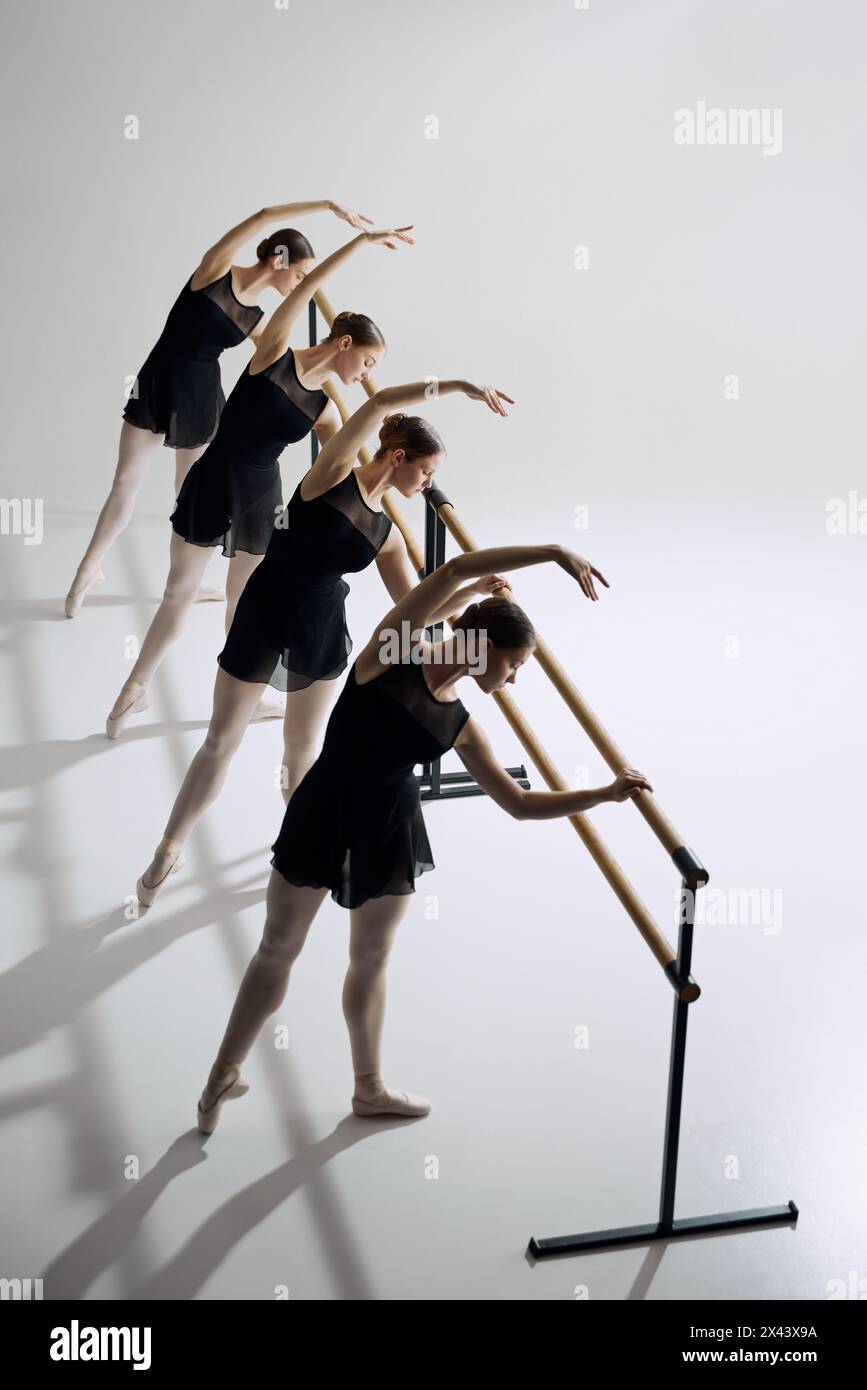Symmetry and grace in ballet. Four flexible girls, ballet dancers ...