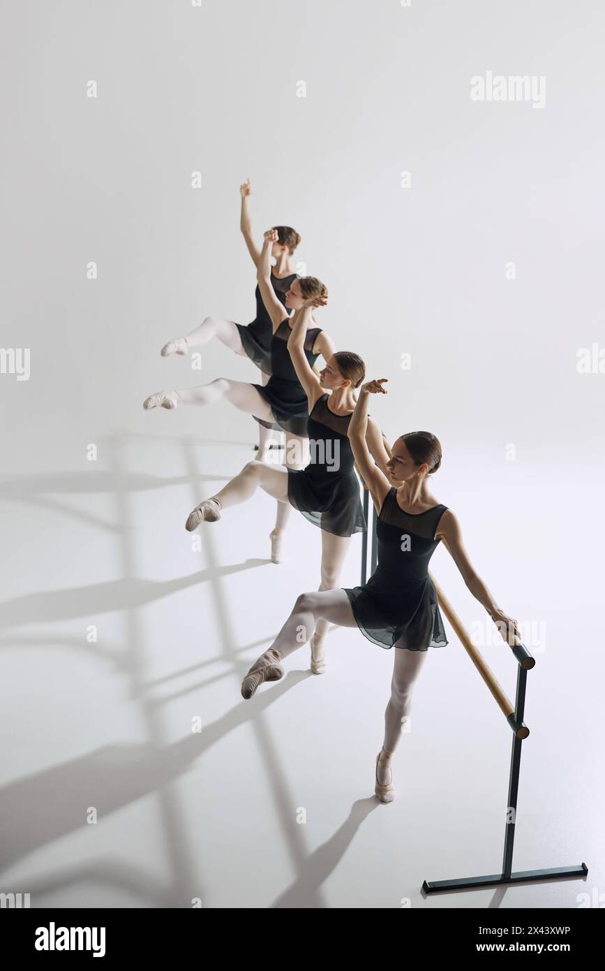 Visual harmony. Top view on four teen girls, ballerinas in black ...