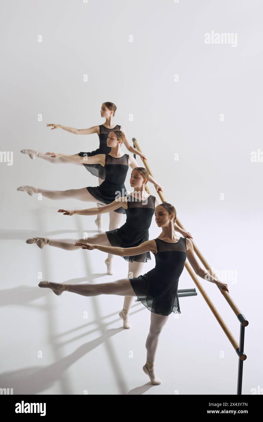 Symmetry and grace in ballet. Four flexible girls, ballet dancers ...