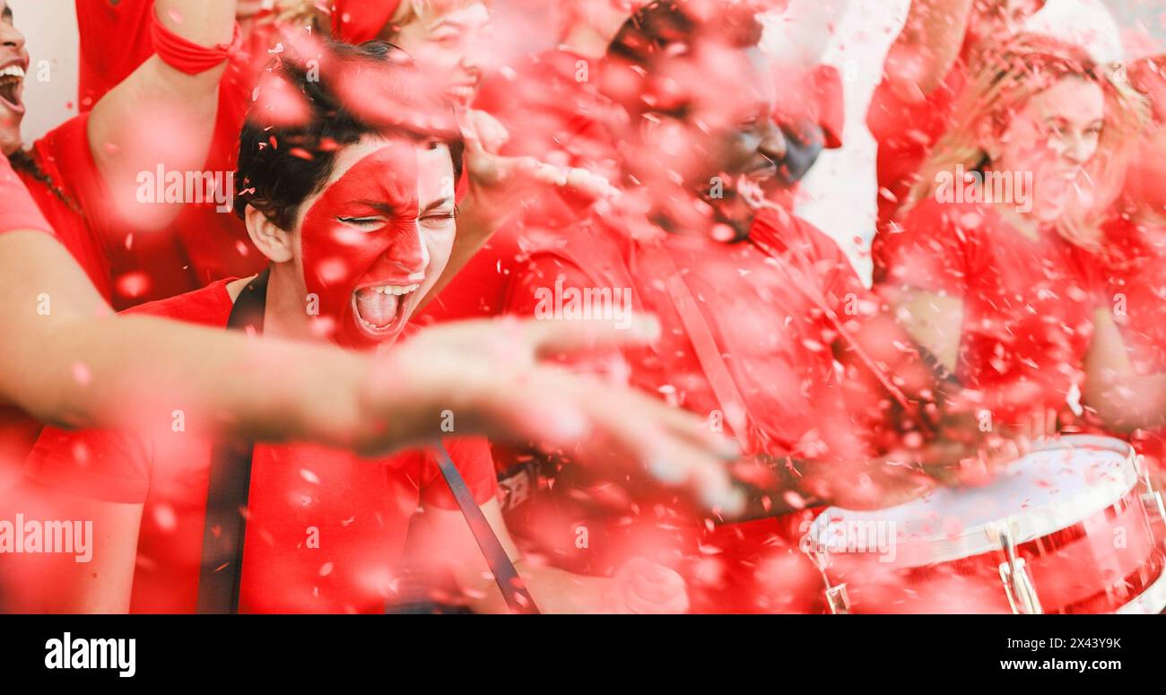 Red sport fans screaming while supporting their team at stadium ...