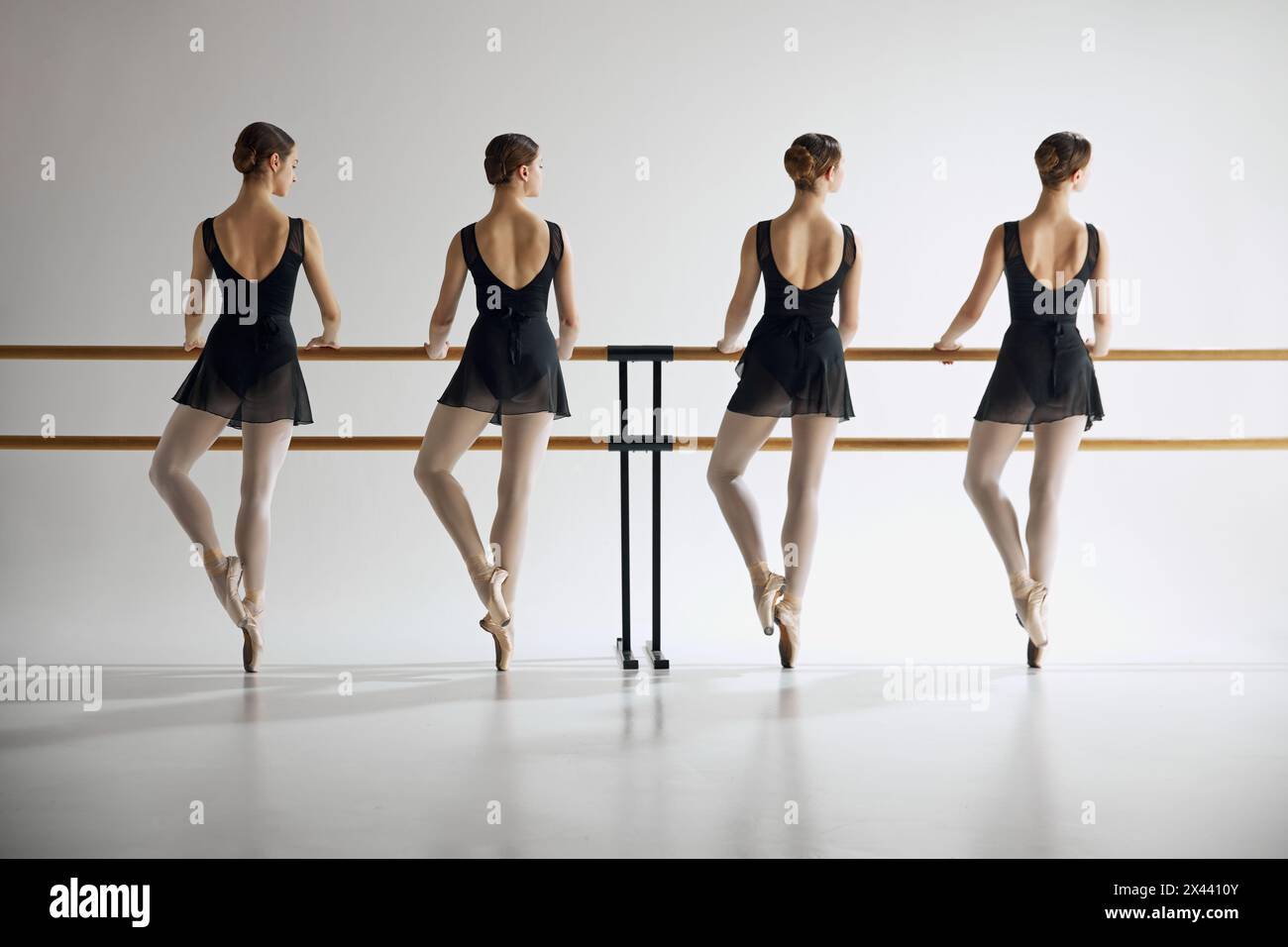 Showing precision. Young girls, ballet dancers in black costumes ...