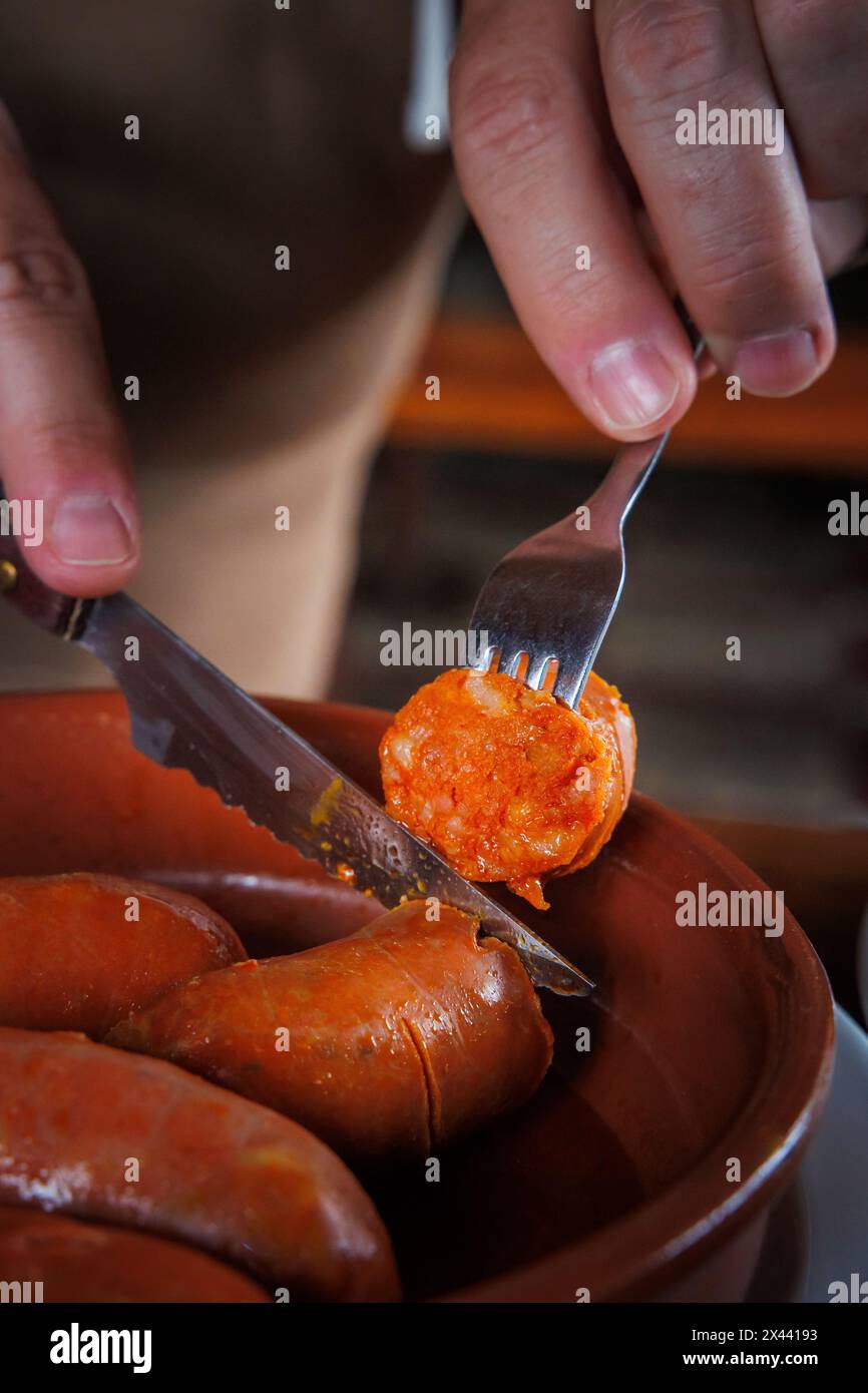fried chorizo plate tapa cut into pieces ready to eat with a fork Stock ...